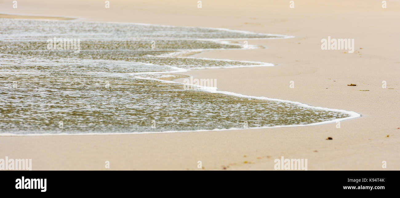 Small ocean sea waves on sandy beach in calm weather. Background ...