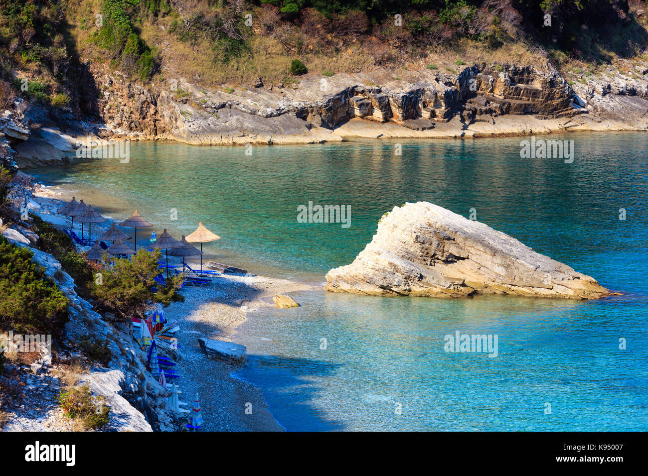 Summer morning Pulebardha beach with sunbeds and sunshades (Saranda ...