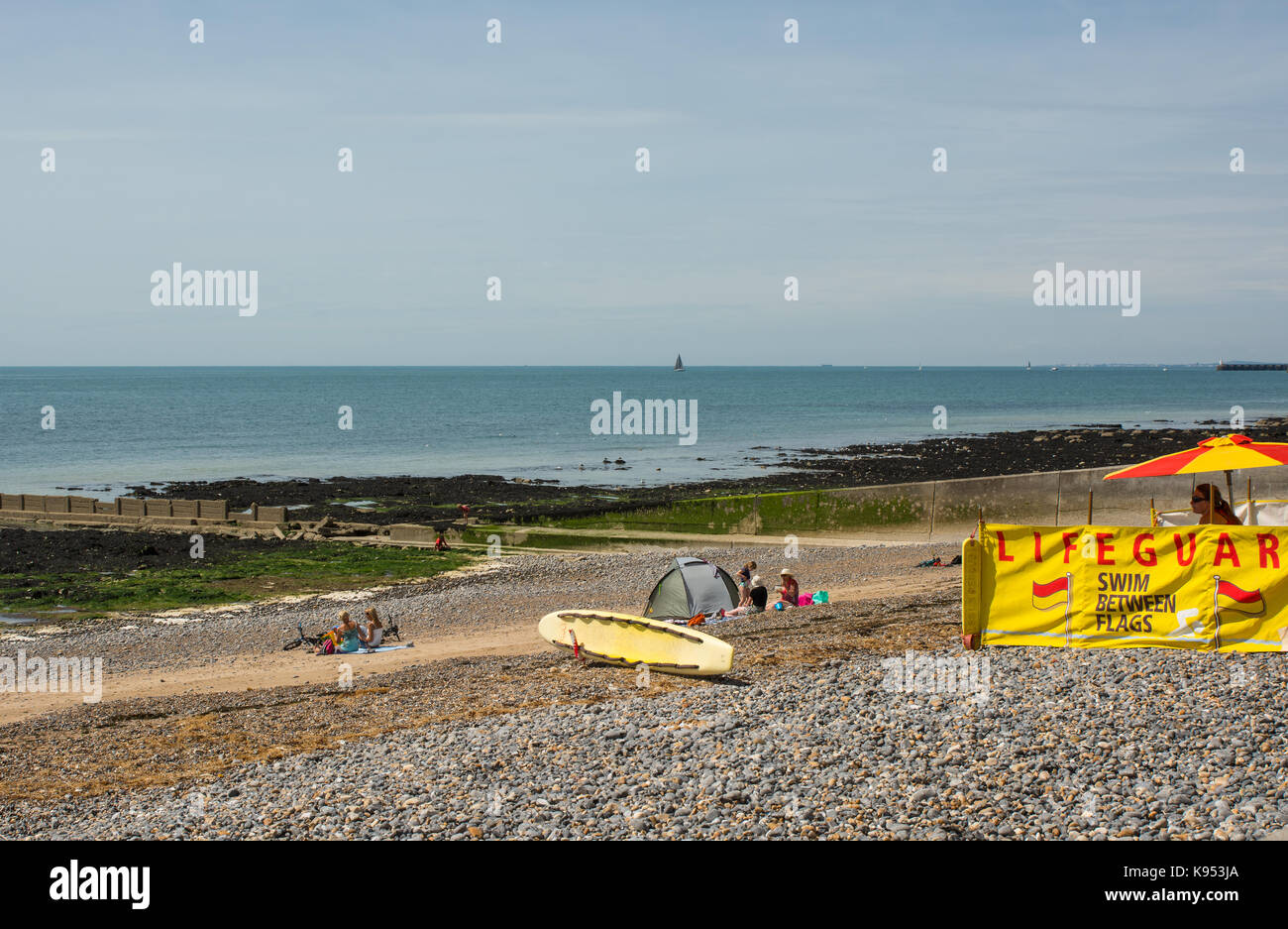Lifeguard watching people on beach at Ovingdean near Brighton, East ...