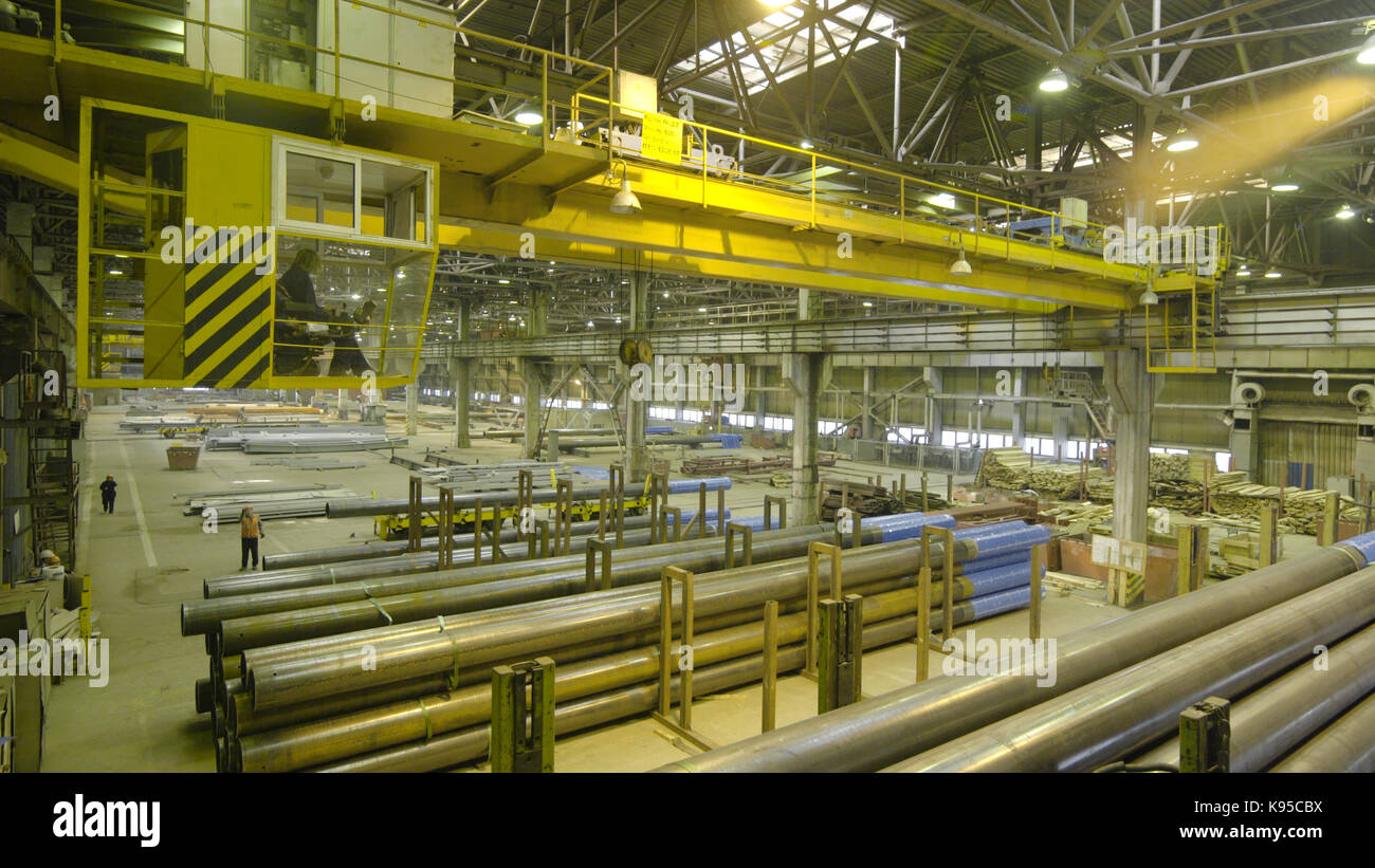 Yellow Indoor Crane. Work hanging of a crane at the plant for the ...