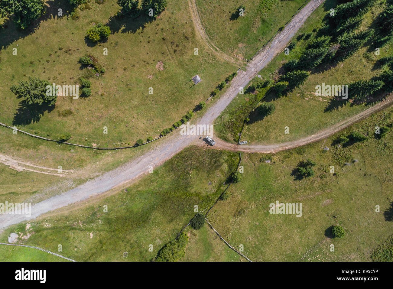 Aerial view over mountain road going through forest landscape Stock ...
