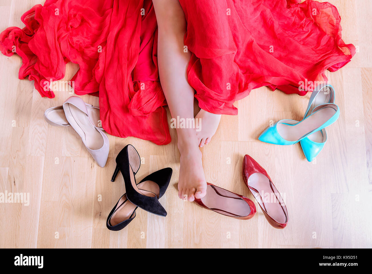 Above image with the bare feet of a Caucasian woman, dressed in a red ...