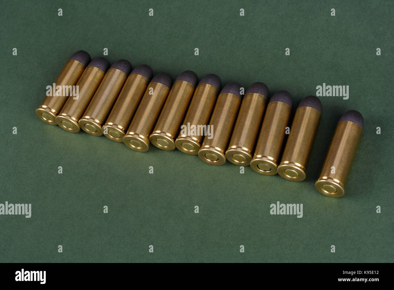 Western-style revolver cartridges on green background Stock Photo - Alamy