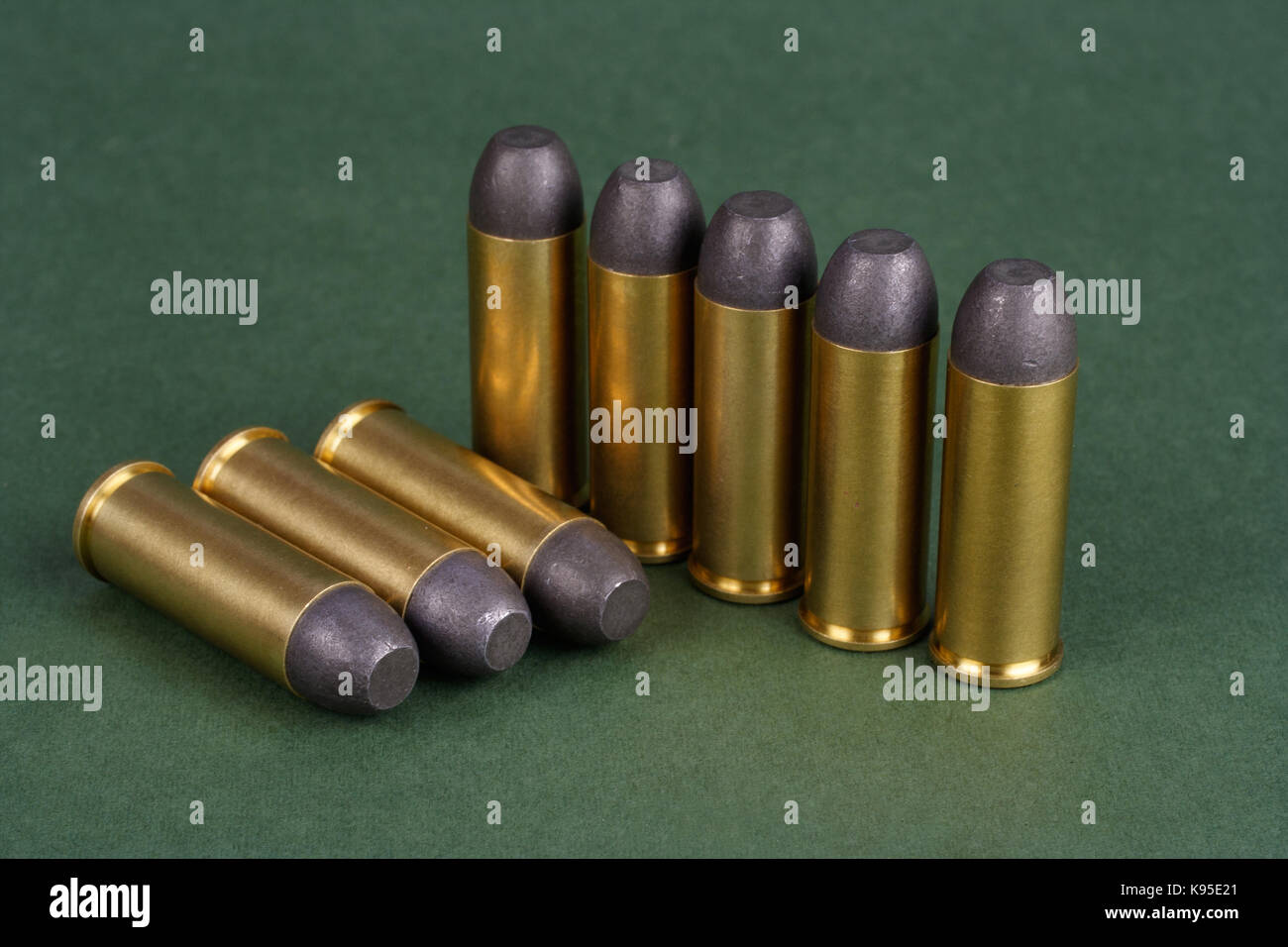 Western-style revolver cartridges on green background Stock Photo - Alamy