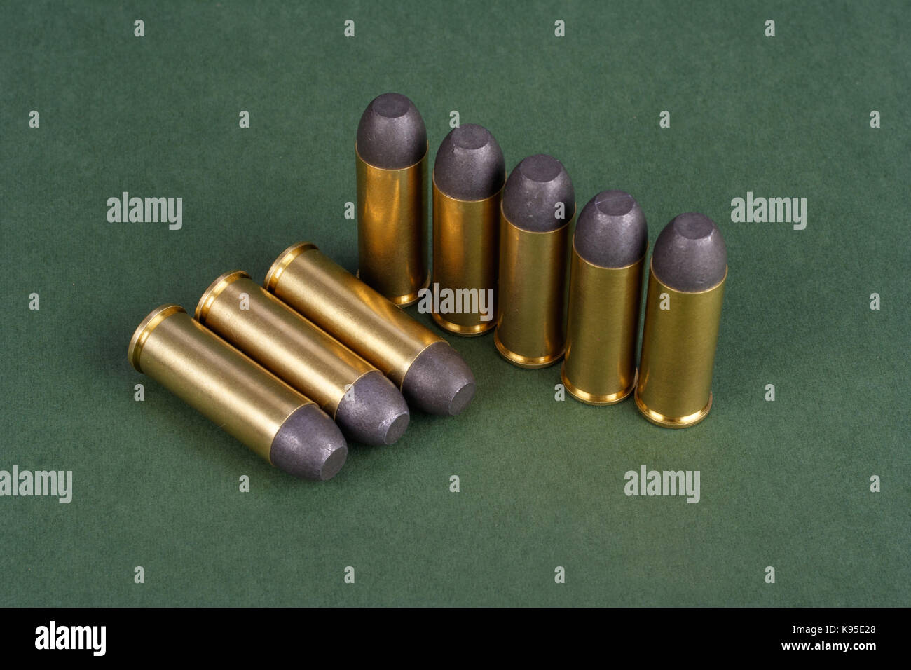 Western-style revolver cartridges on green background Stock Photo - Alamy