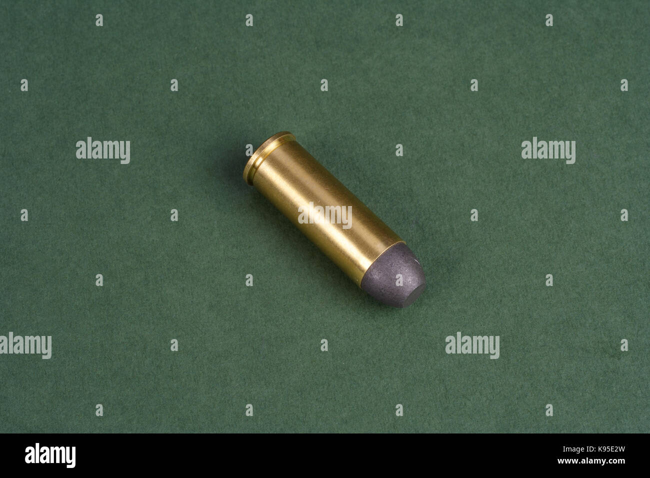 Western-style revolver cartridges on green background Stock Photo - Alamy