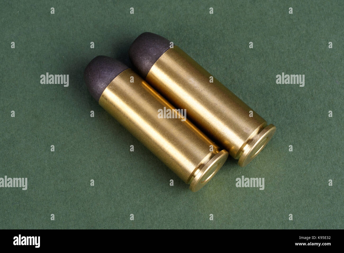 Western-style revolver cartridges on green background Stock Photo - Alamy