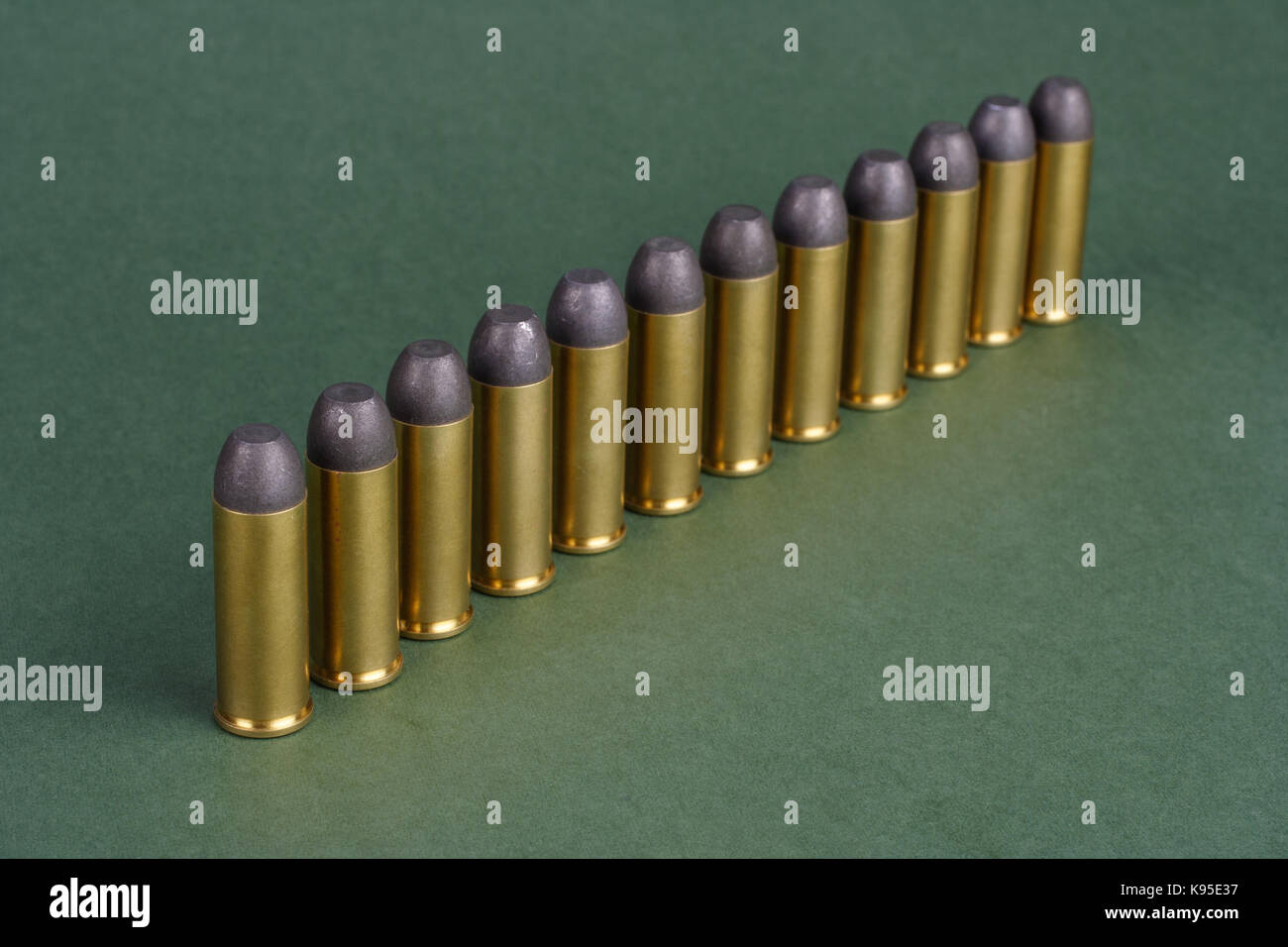 Western-style revolver cartridges on green background Stock Photo - Alamy