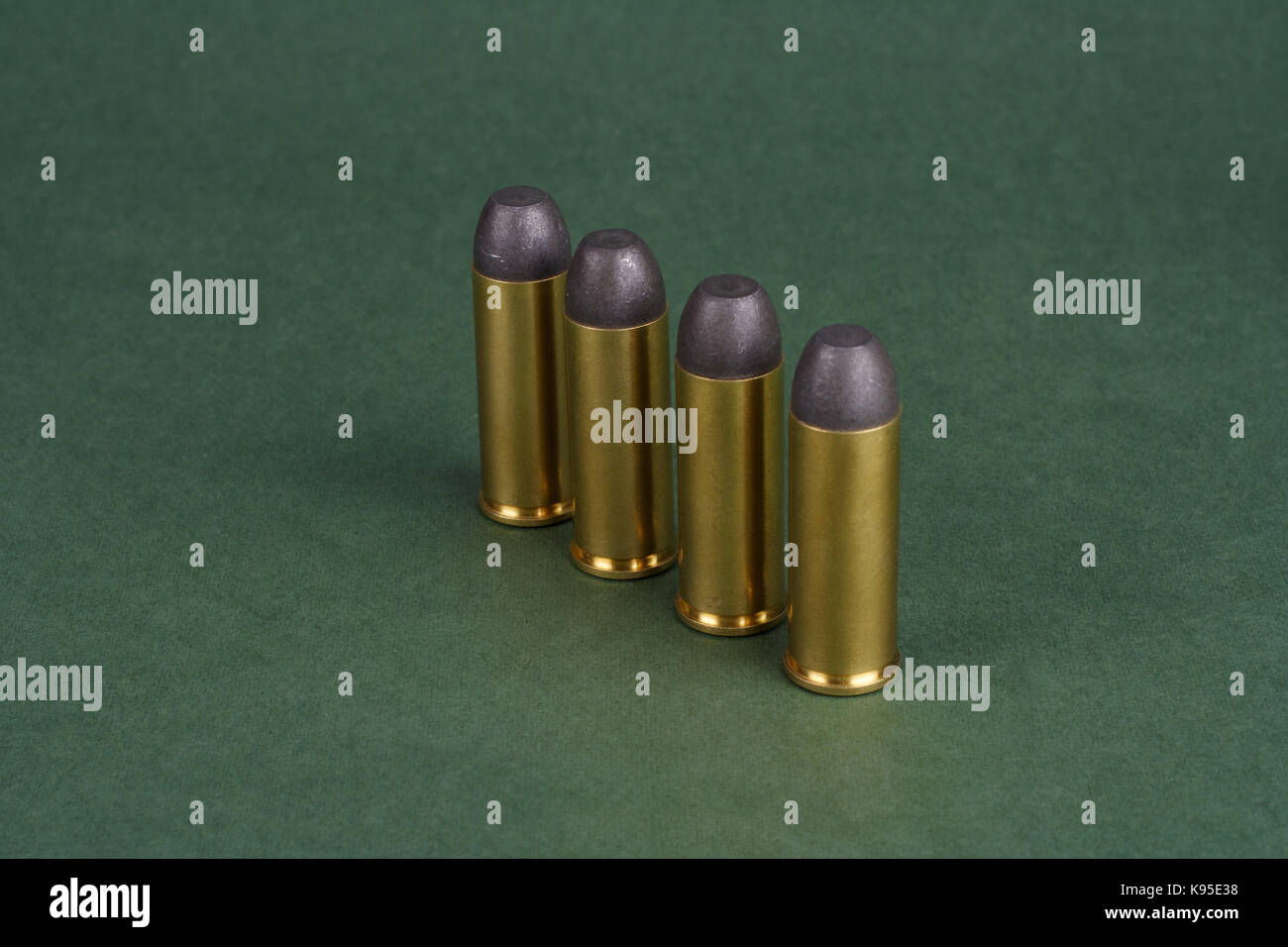 Western-style revolver cartridges on green background Stock Photo - Alamy