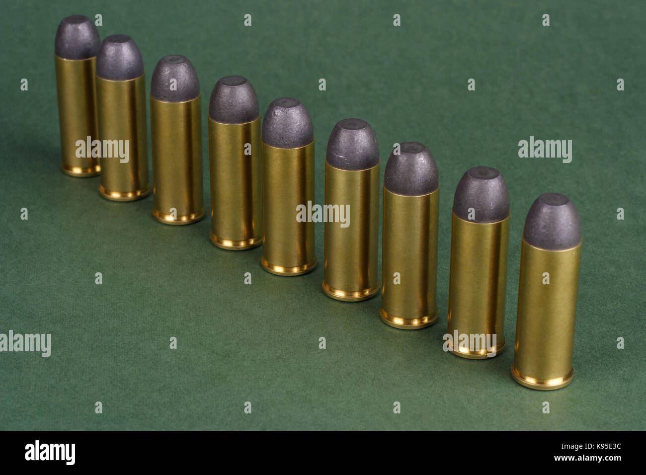 Western-style revolver cartridges on green background Stock Photo - Alamy