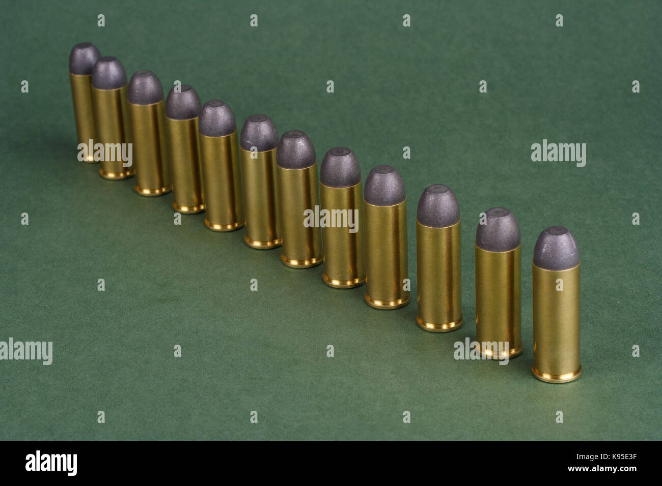Western-style revolver cartridges on green background Stock Photo - Alamy