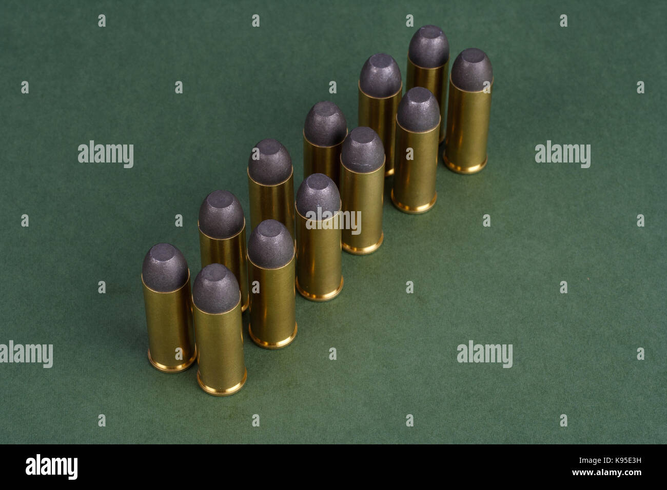Western-style revolver cartridges on green background Stock Photo - Alamy