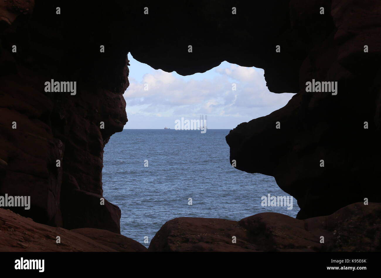 Oil Rig Rowan Stravanger under tow viewed through Needles Eye rock arch ...