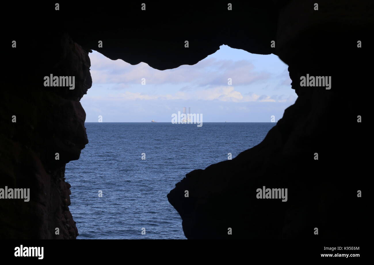 Oil Rig Rowan Stravanger under tow viewed through Needles Eye rock arch ...