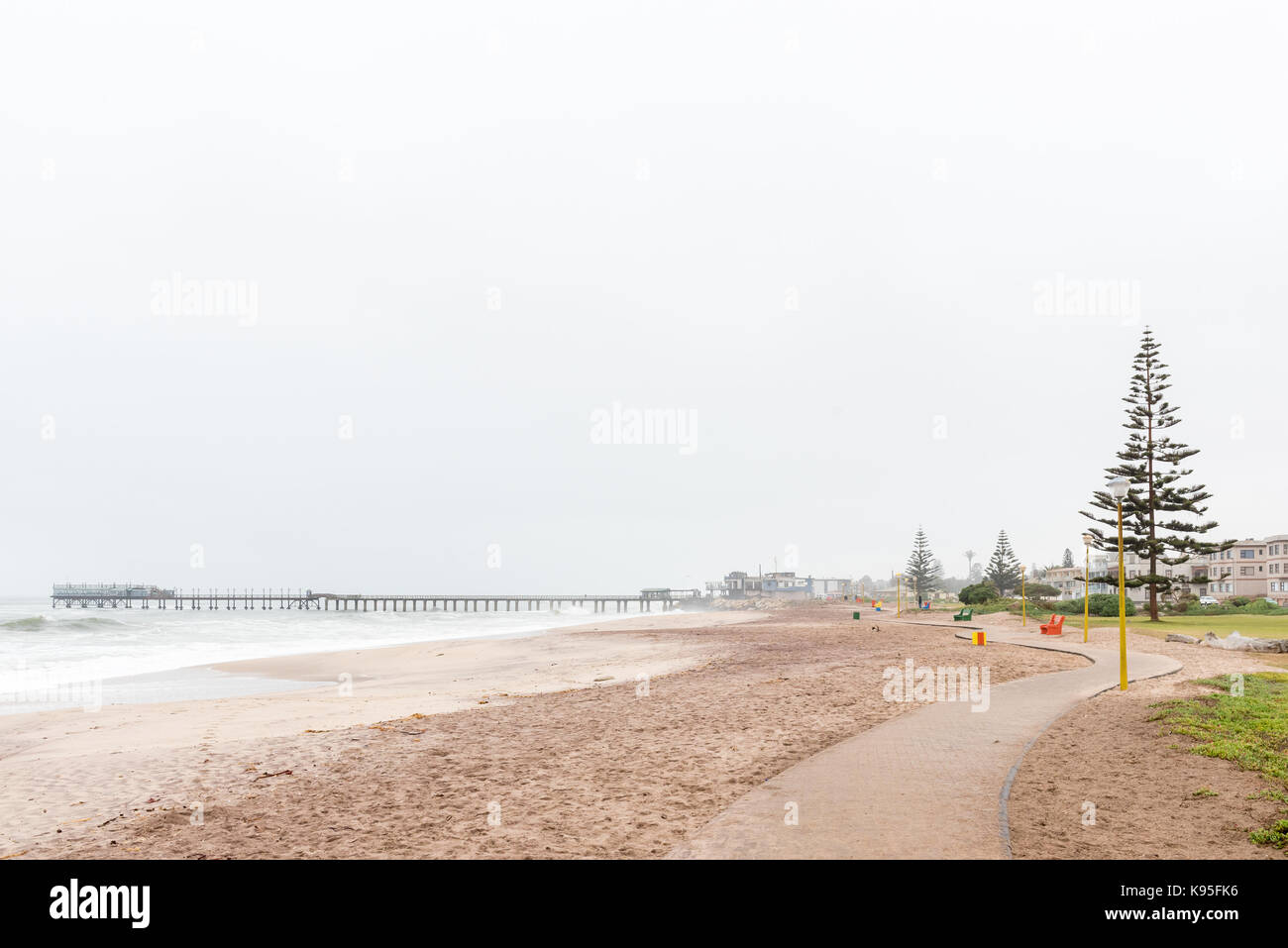 A beach scene, with the historic jetty in the back, in Swakopmund in ...