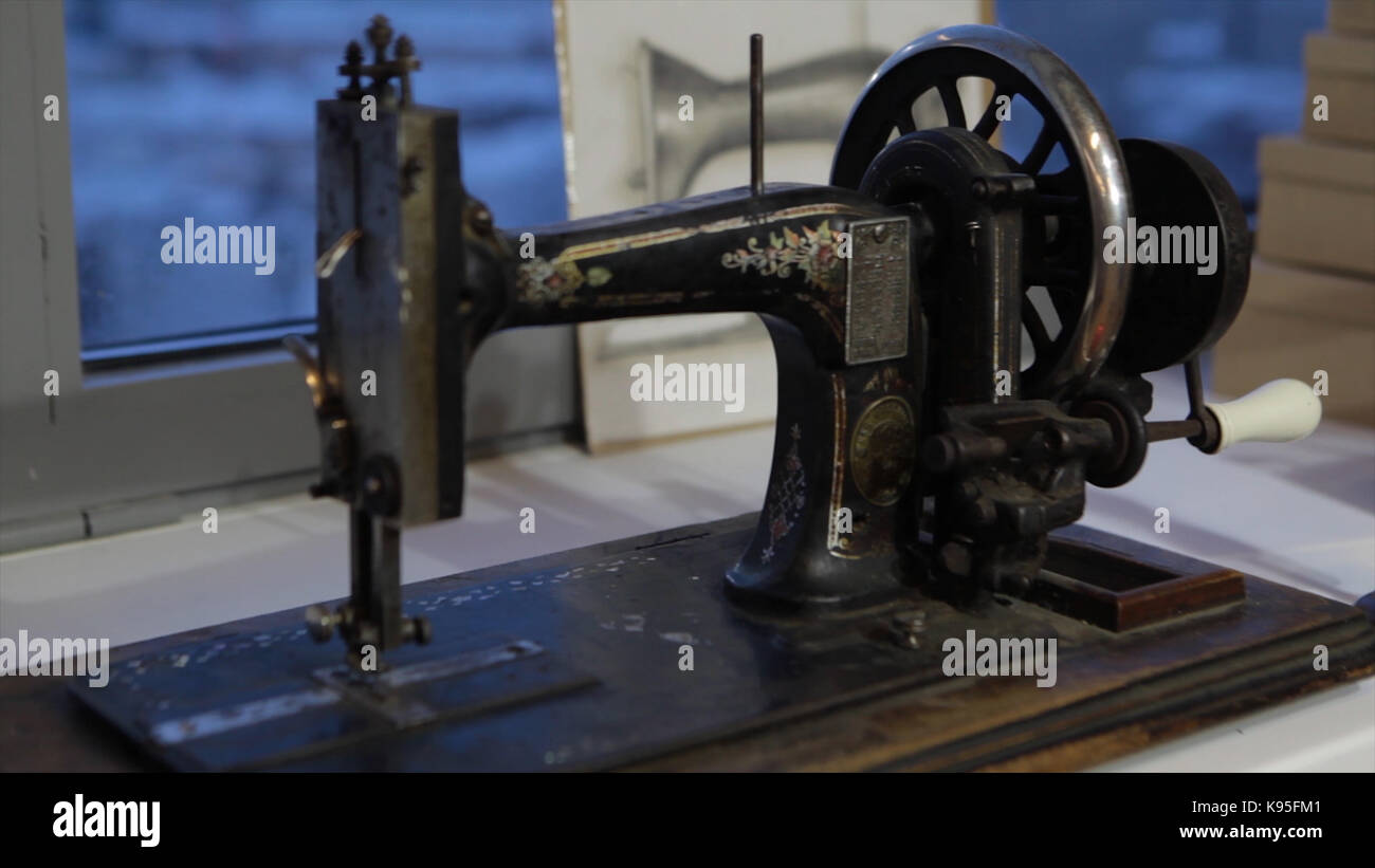 Sewing machine, seamstress sewing at machine and women's hands. Antique ...