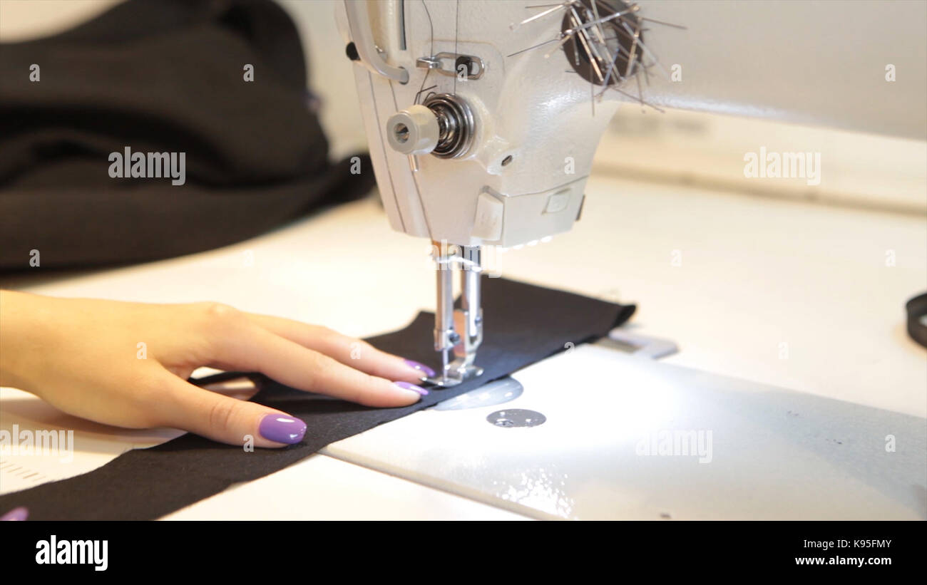 Sewing machine, seamstress sewing at machine and women's hands. Antique ...