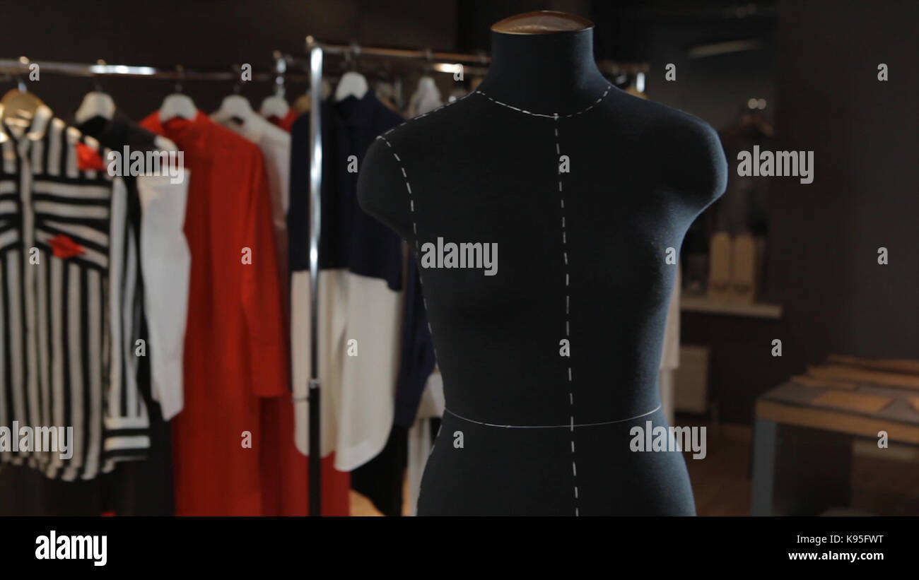 Empty black mannequin in the background light is in the middle of the ...