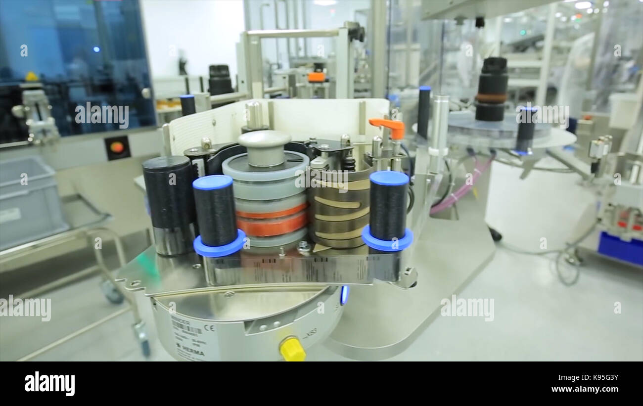 Pharmaceutics. Pharmaceutical worker operates tablet blister packaging ...
