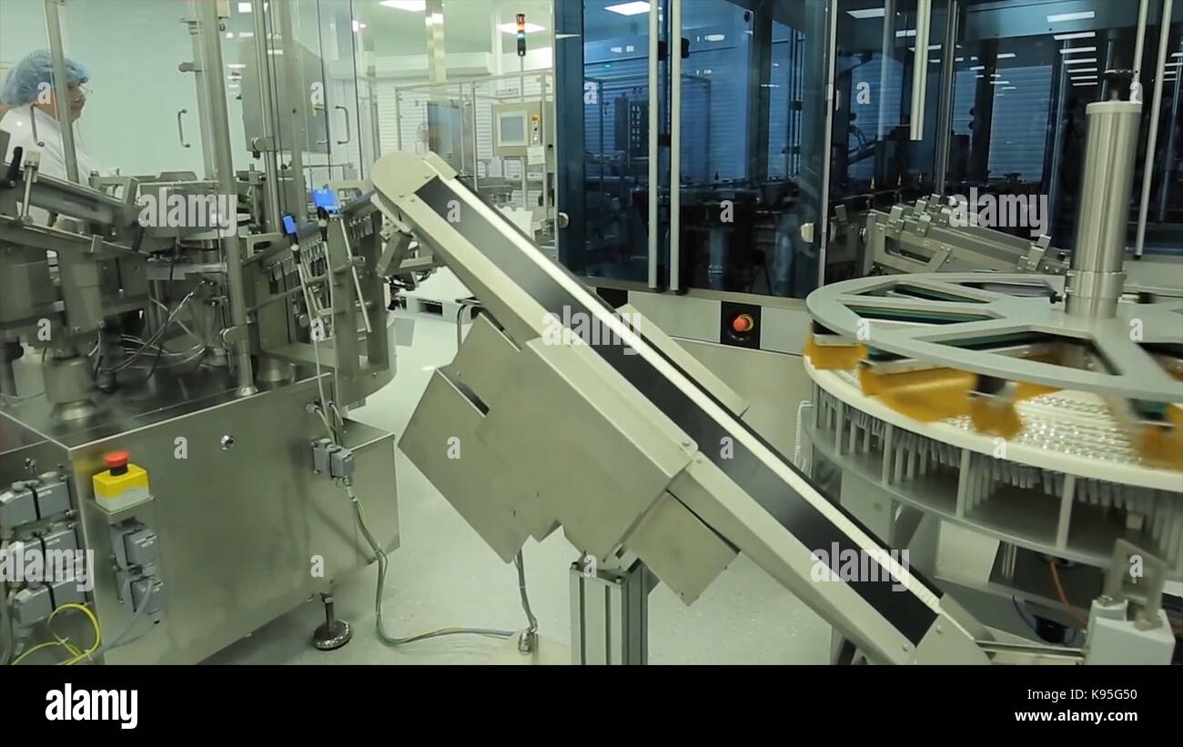 Pharmaceutics. Pharmaceutical worker operates tablet blister packaging ...
