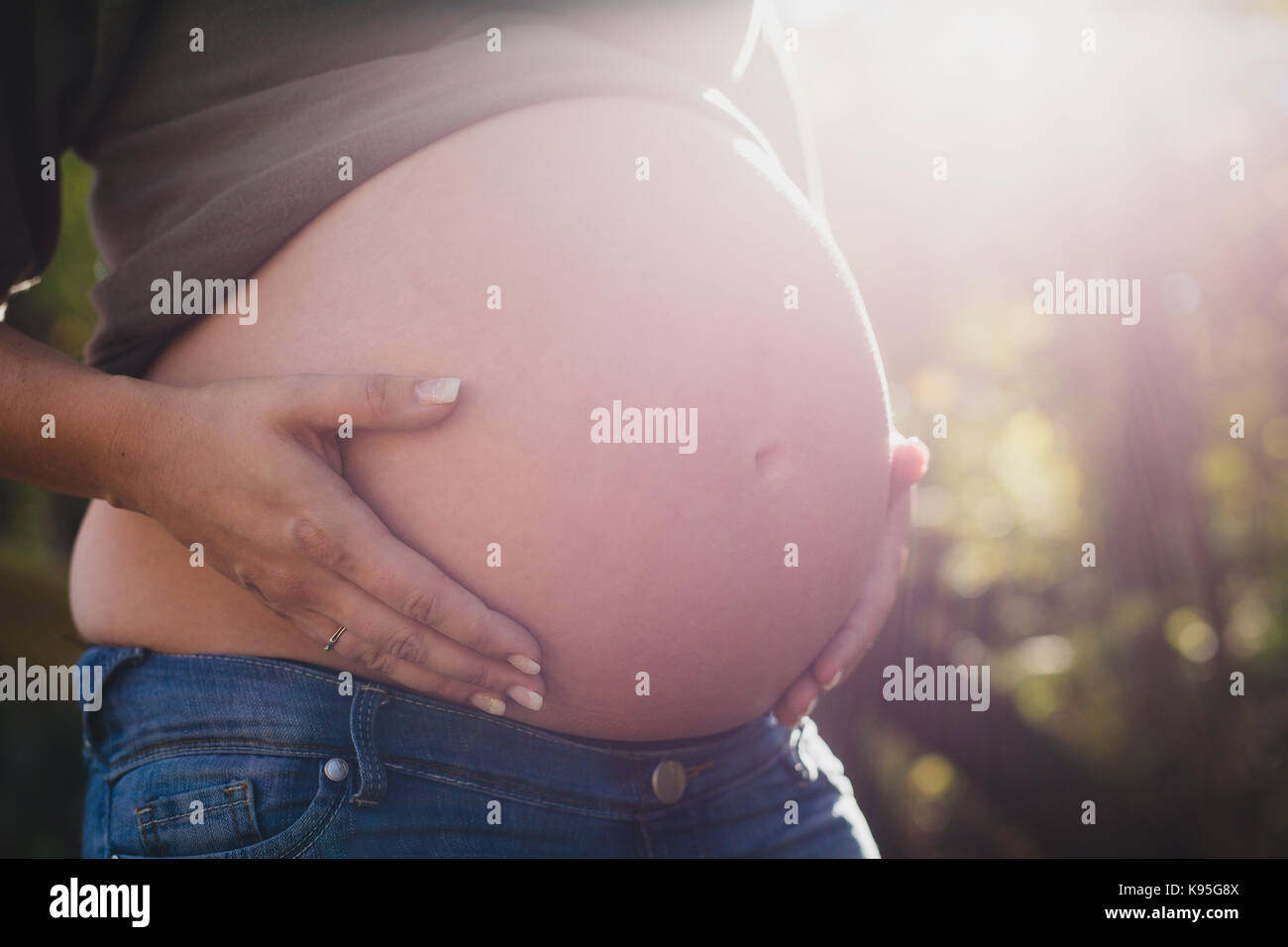 Closeup pregnant she use hand touch belly Stock Photo - Alamy