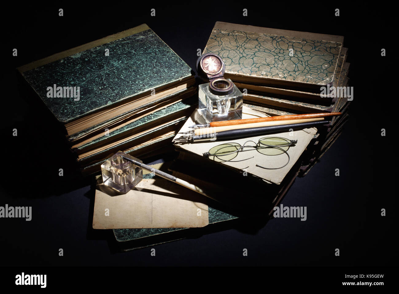 old books, papers, ink pen and inkpot on black background Stock Photo ...