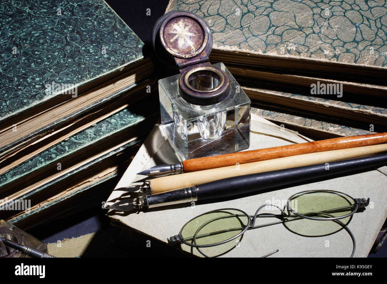 old books, papers, ink pen and inkpot on black background Stock Photo ...