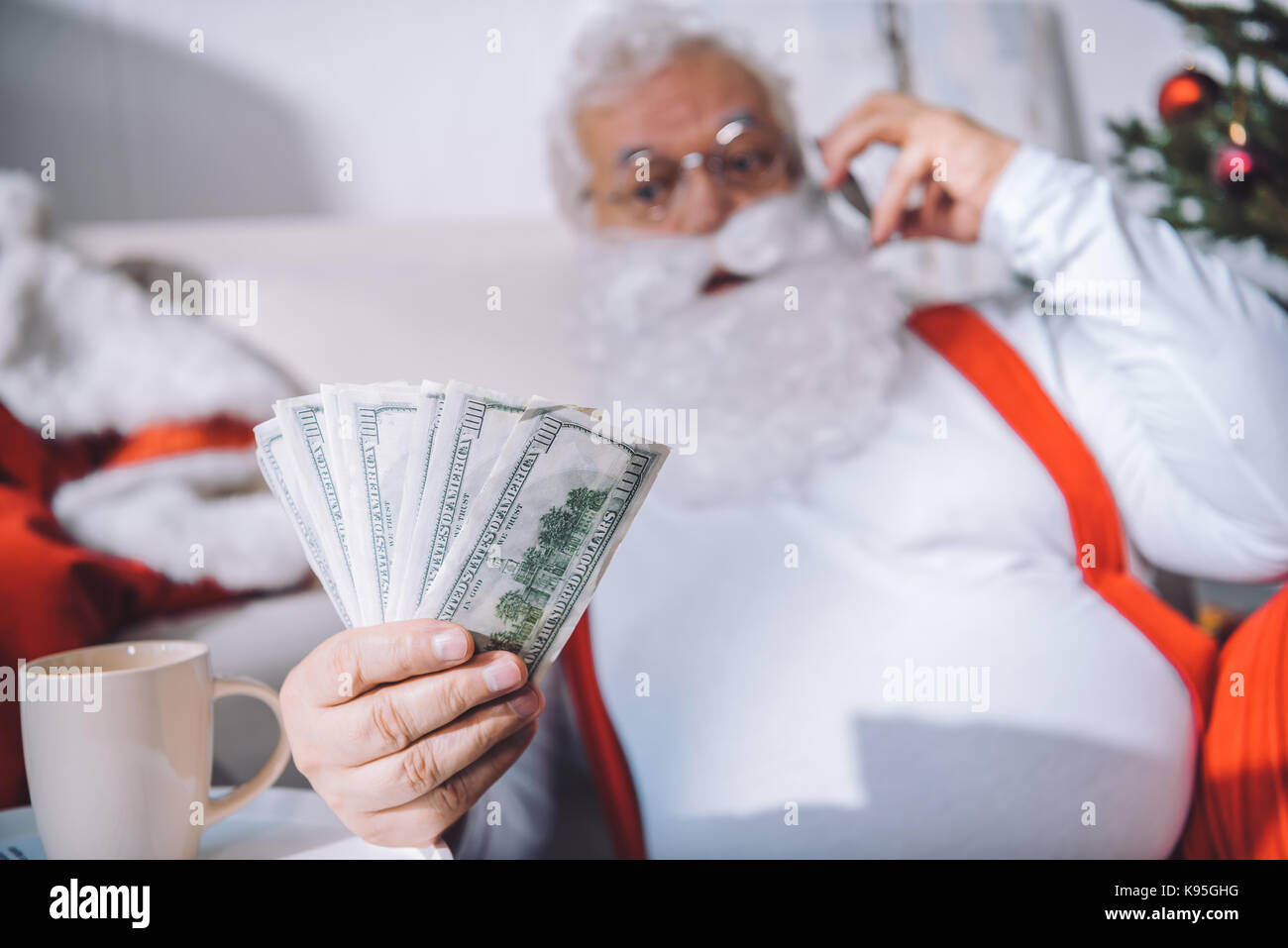 santa claus with cash in hand Stock Photo - Alamy