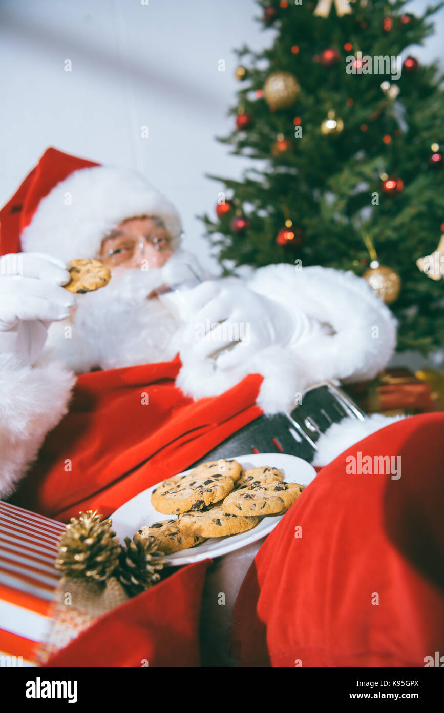 Santa eating cookies hi-res stock photography and images - Alamy