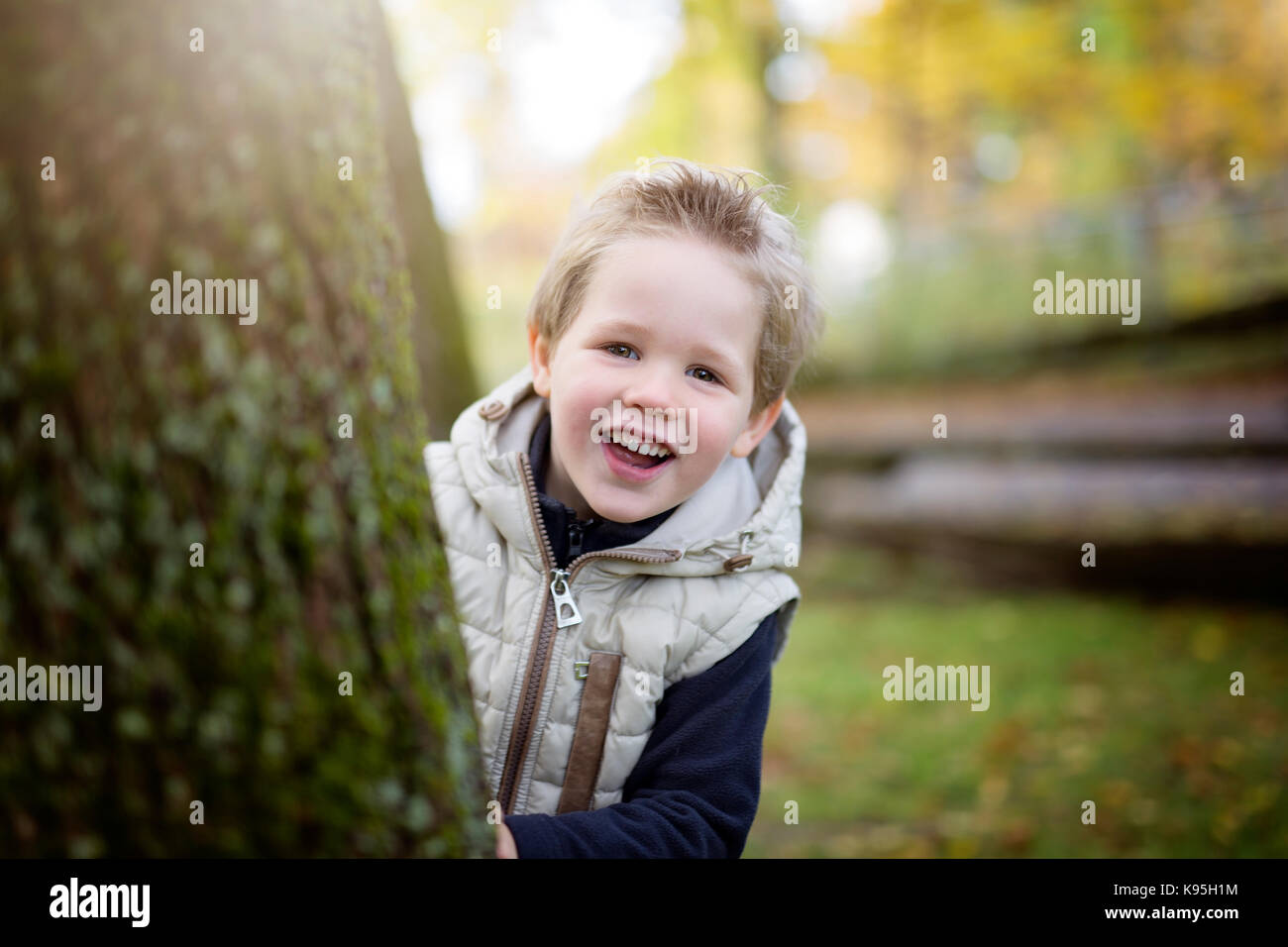 boy in autumn season in a park Stock Photo - Alamy