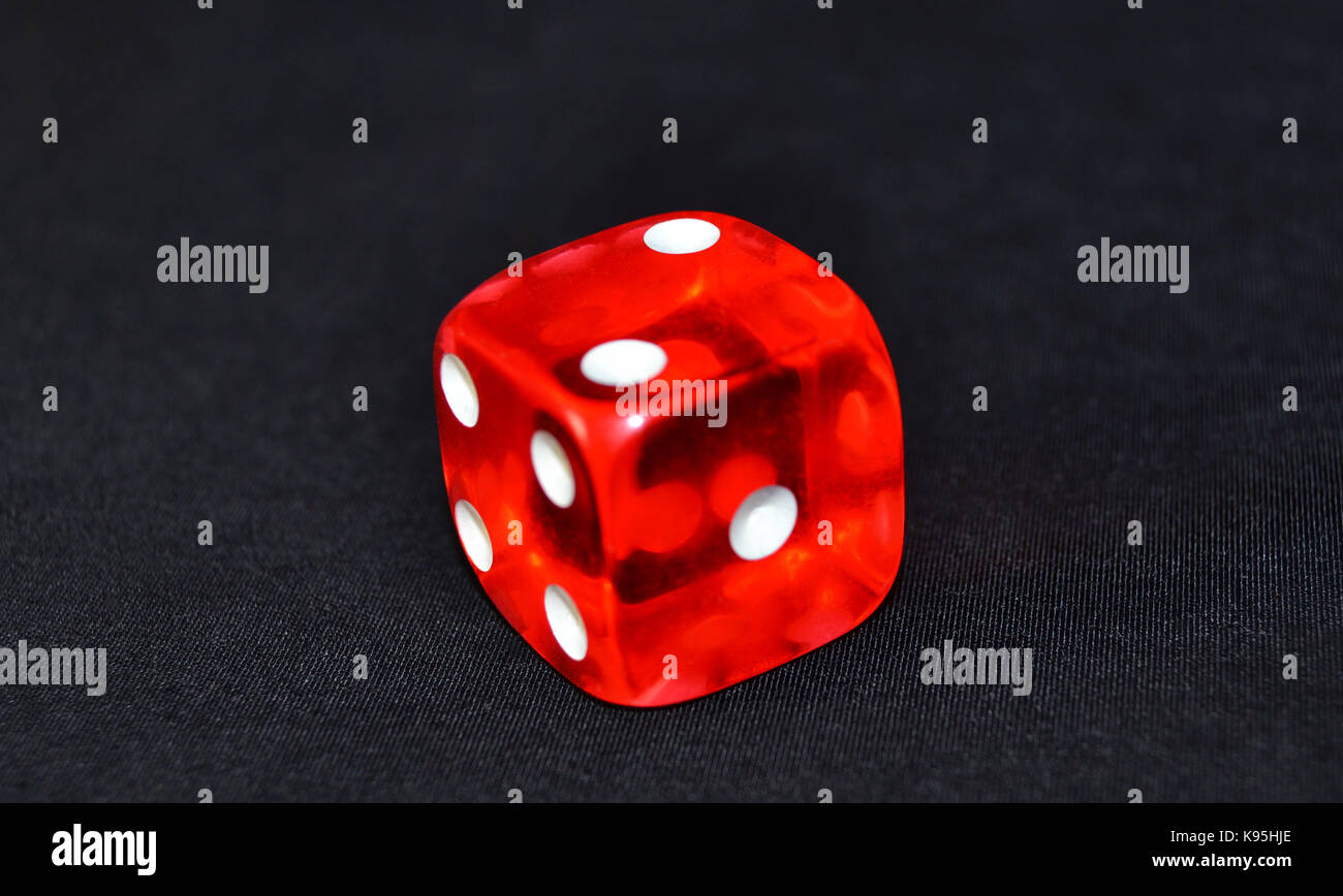 Single Red Die with Dark Grey Background Stock Photo - Alamy