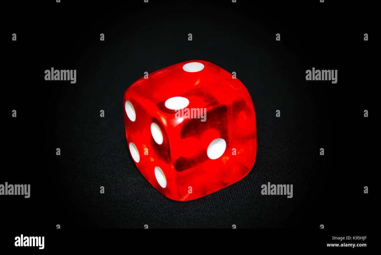 Single Red Die with Black Background Stock Photo - Alamy