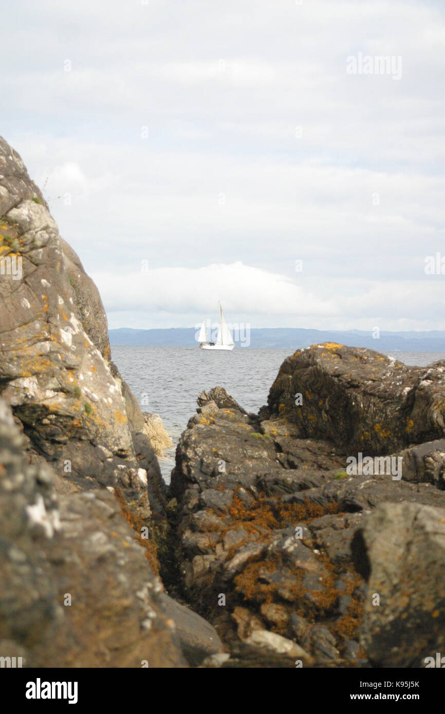 Photo of sailing boat from rocky beach Tarbert Scotland Stock Photo - Alamy