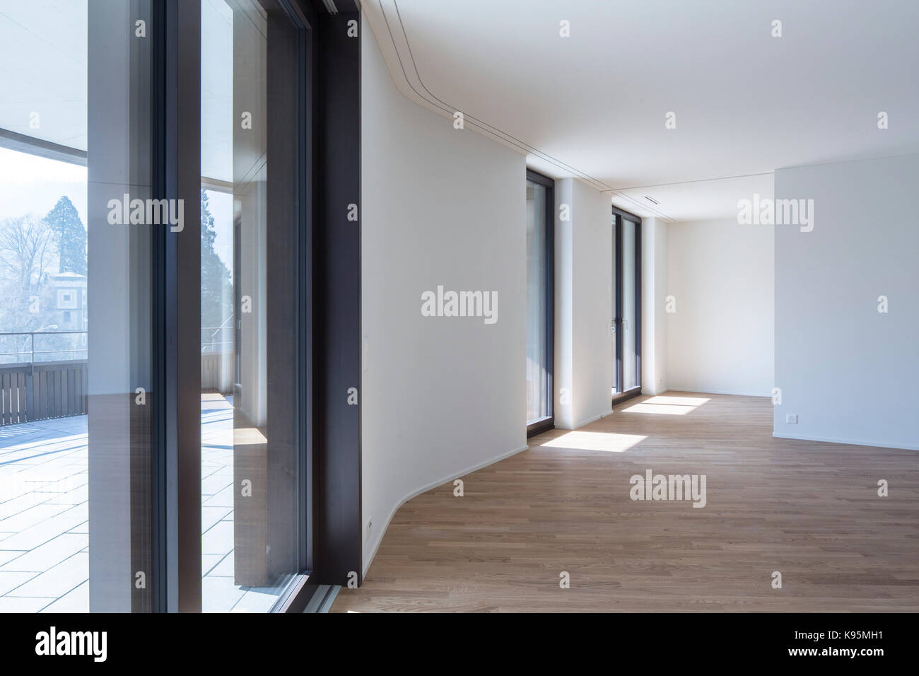 Room with full-height windows and balcony access. Housing estate ...