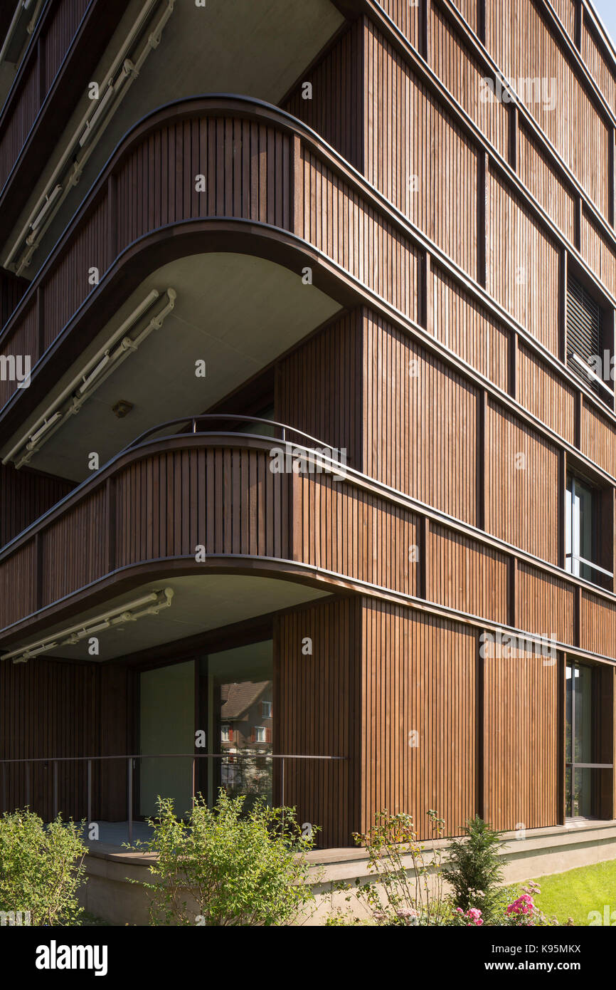 Corner elevation with timber clad curved balconies. Housing estate ...