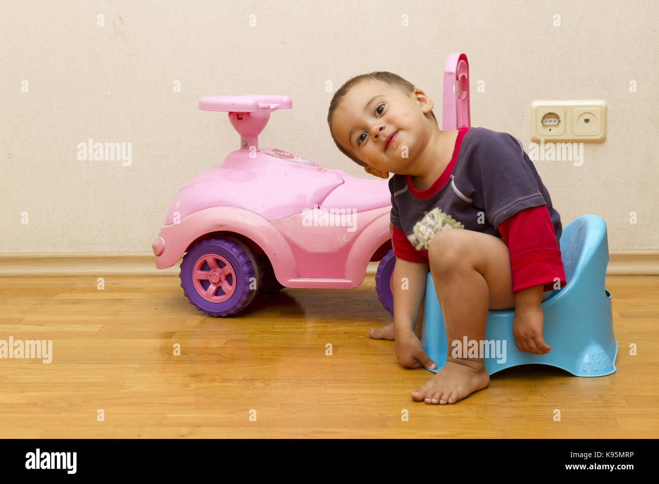 Happy toddler sitting on potty in home interior Stock Photo - Alamy