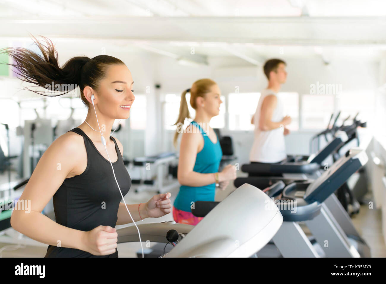 People running on treadmill at gym Stock Photo - Alamy