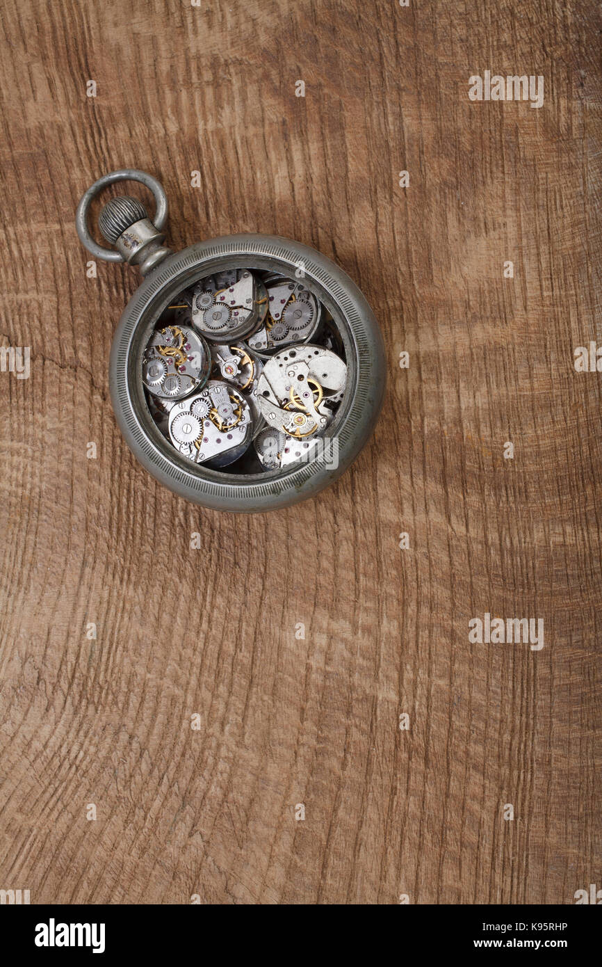 broken vintage pocket watch on wooden background Stock Photo - Alamy