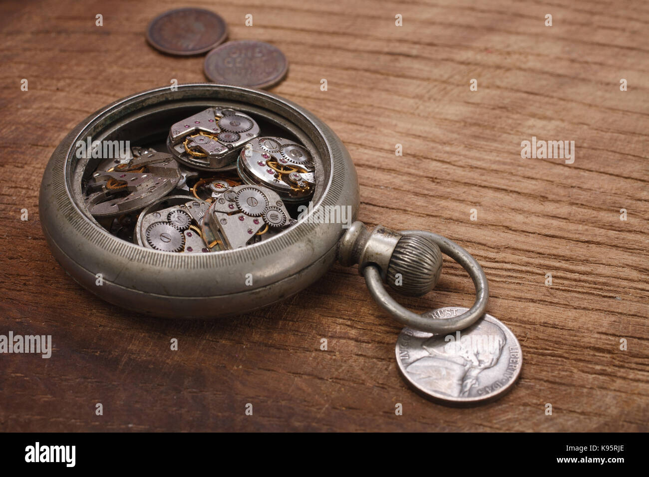 broken vintage pocket watch on wooden background Stock Photo - Alamy