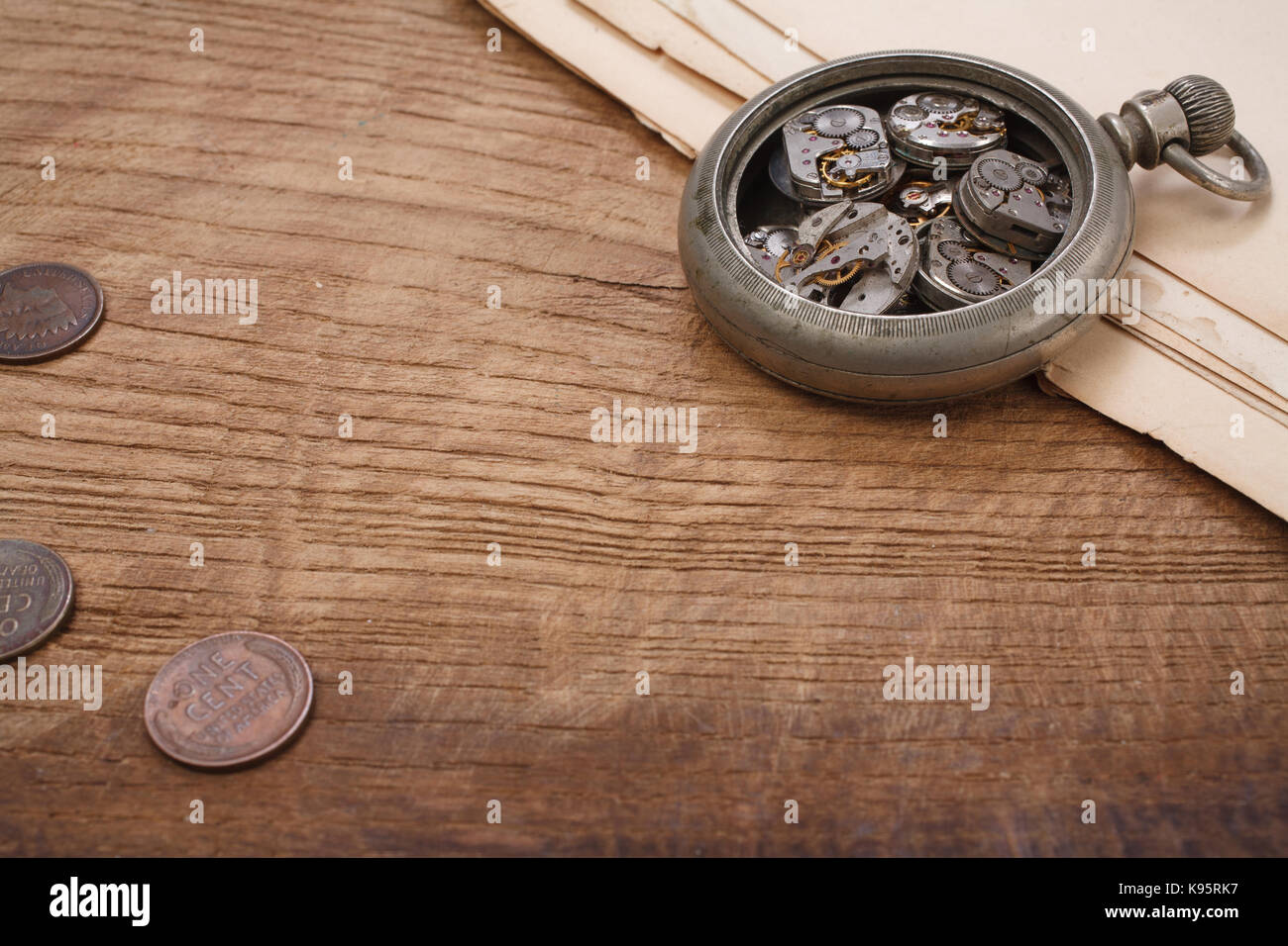 broken vintage pocket watch on wooden background Stock Photo - Alamy