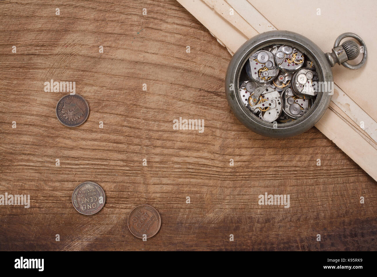 broken vintage pocket watch on wooden background Stock Photo - Alamy