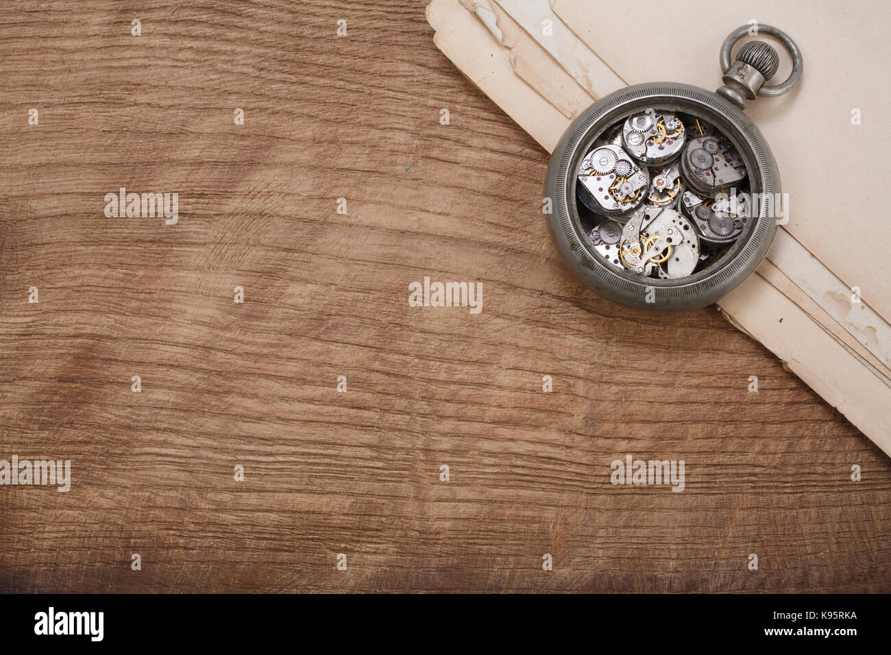 broken vintage pocket watch on wooden background Stock Photo - Alamy