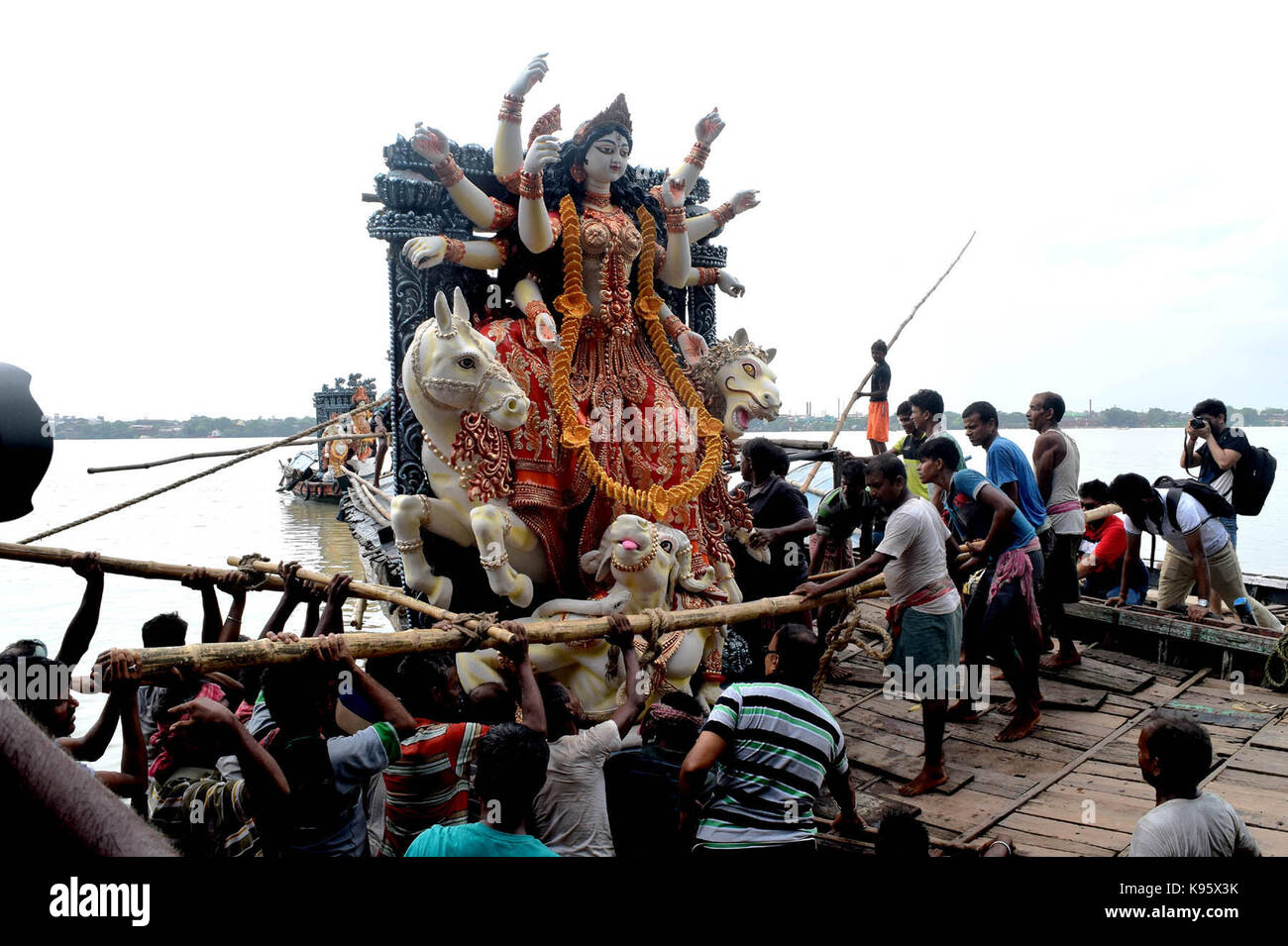 A clay statue of the Indian Hindu goddess Durga is transported from a ...