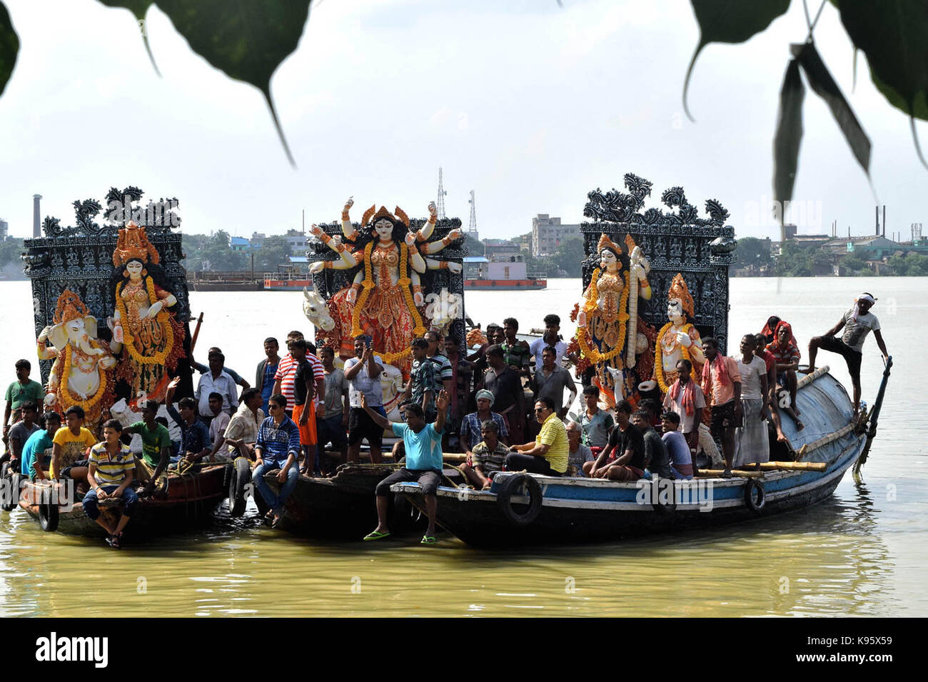 A clay statue of the Indian Hindu goddess Durga is transported from a ...
