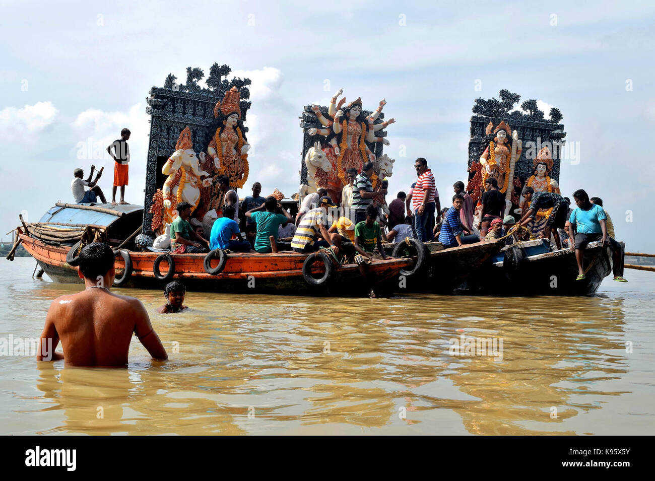 A clay statue of the Indian Hindu goddess Durga is transported from a ...