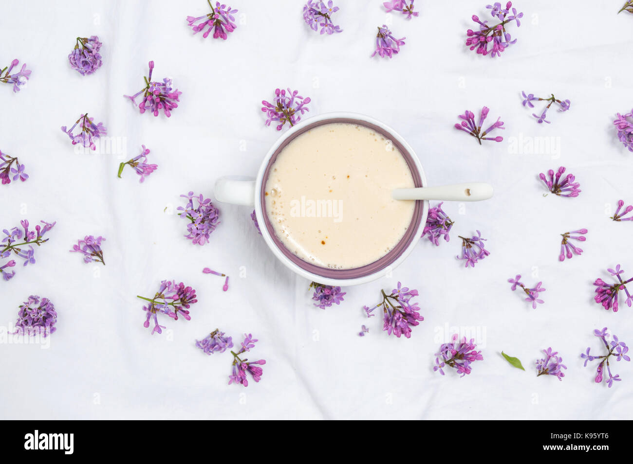 Coffee with milk and purple flowers on white fabric Stock Photo - Alamy