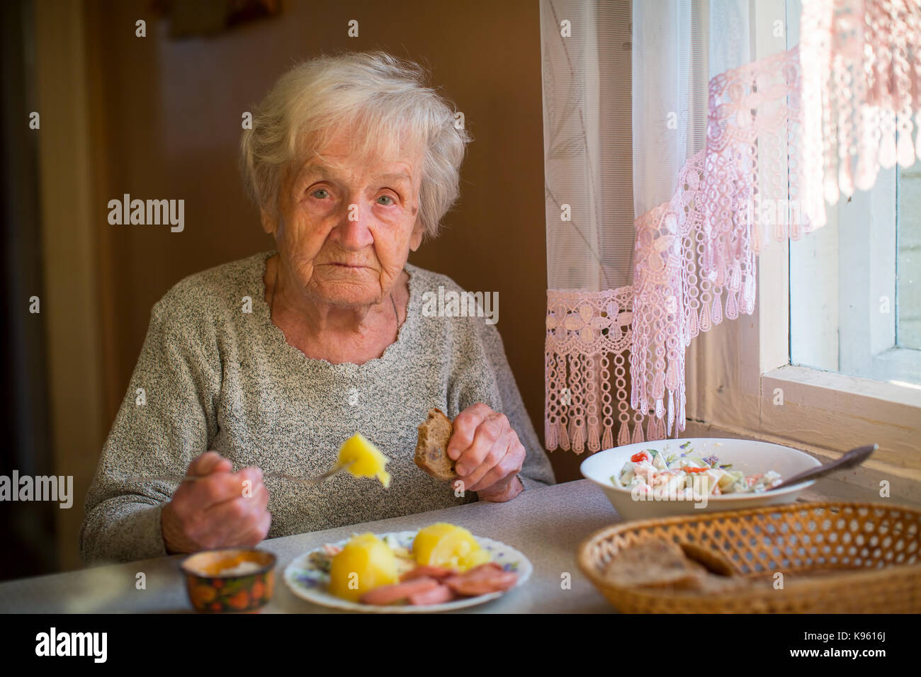 Old woman alone at cafe table hi-res stock photography and images - Alamy