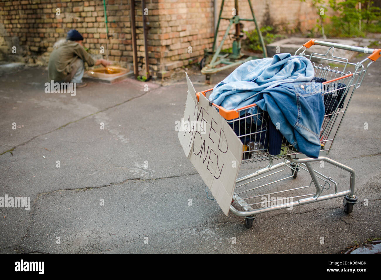 On front view shopping cart with belongings oh tramp, old man washing ...