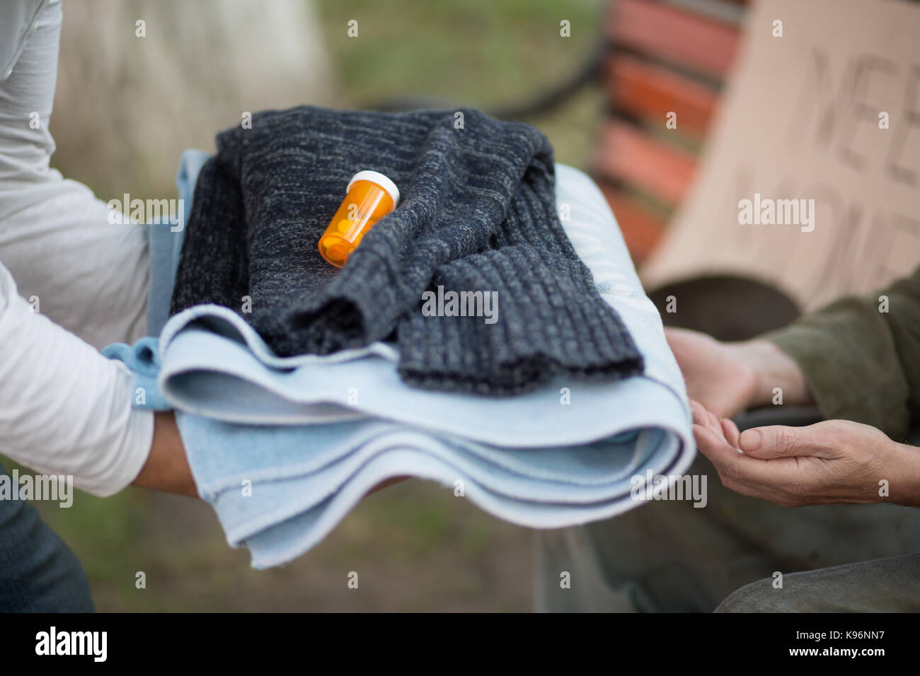 Close up view of hands with warm clothes towel and medicine for ...