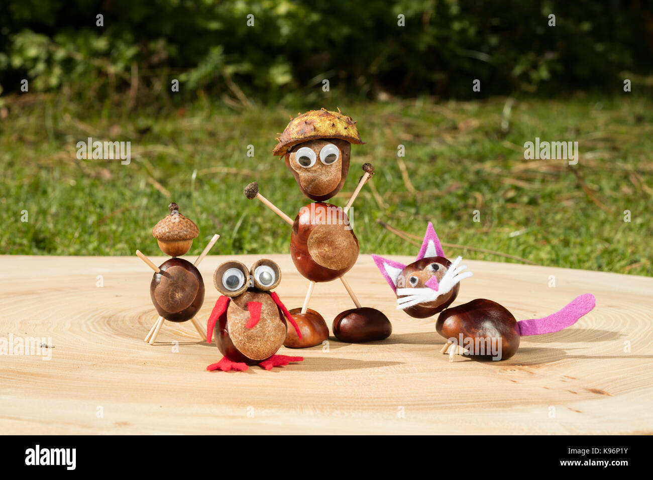 Group of little characters or figurines made with chestnuts on a wooden ...